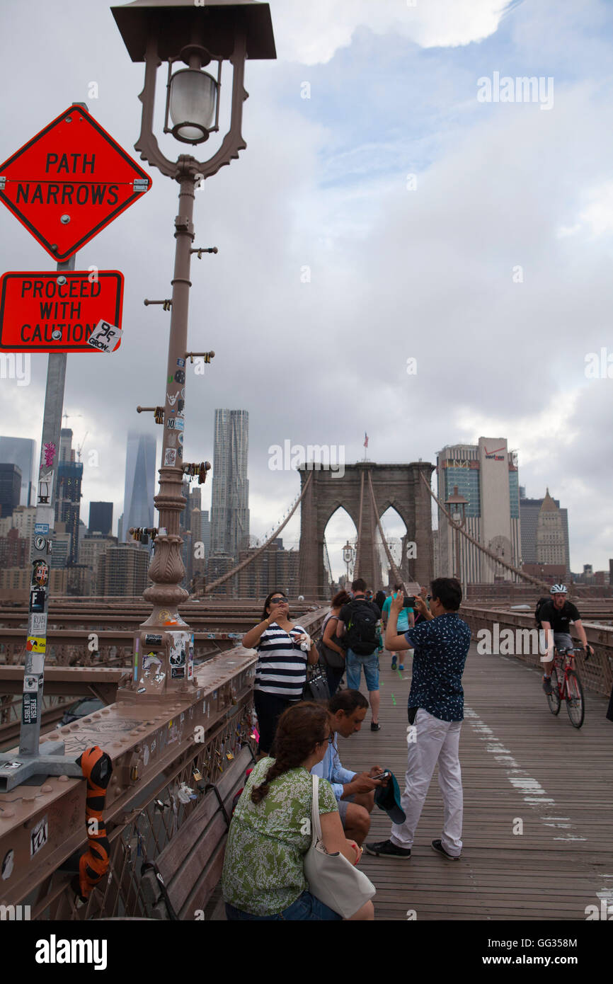 People take photos on the Brooklyn Bridge in New York City Stock Photo ...