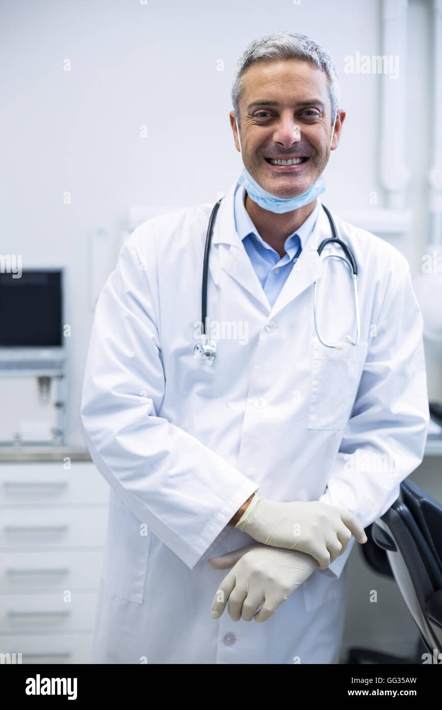 Smiling dentist standing in dental clinic Stock Photo - Alamy