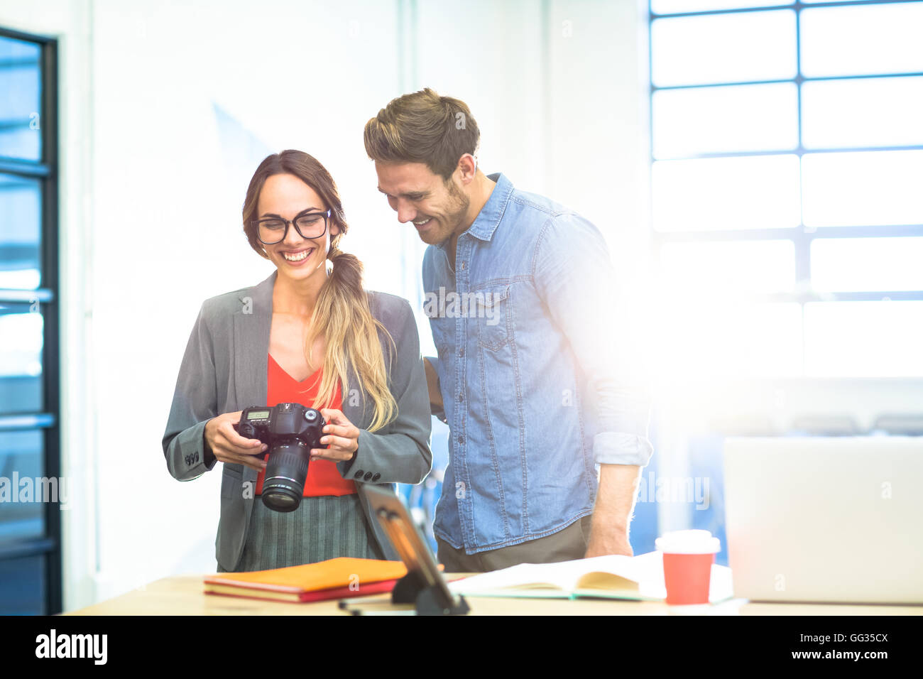 Business executives checking photos in camera Stock Photo - Alamy