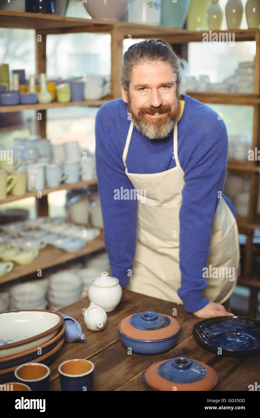 Portrait of male potter standing at table Stock Photo - Alamy