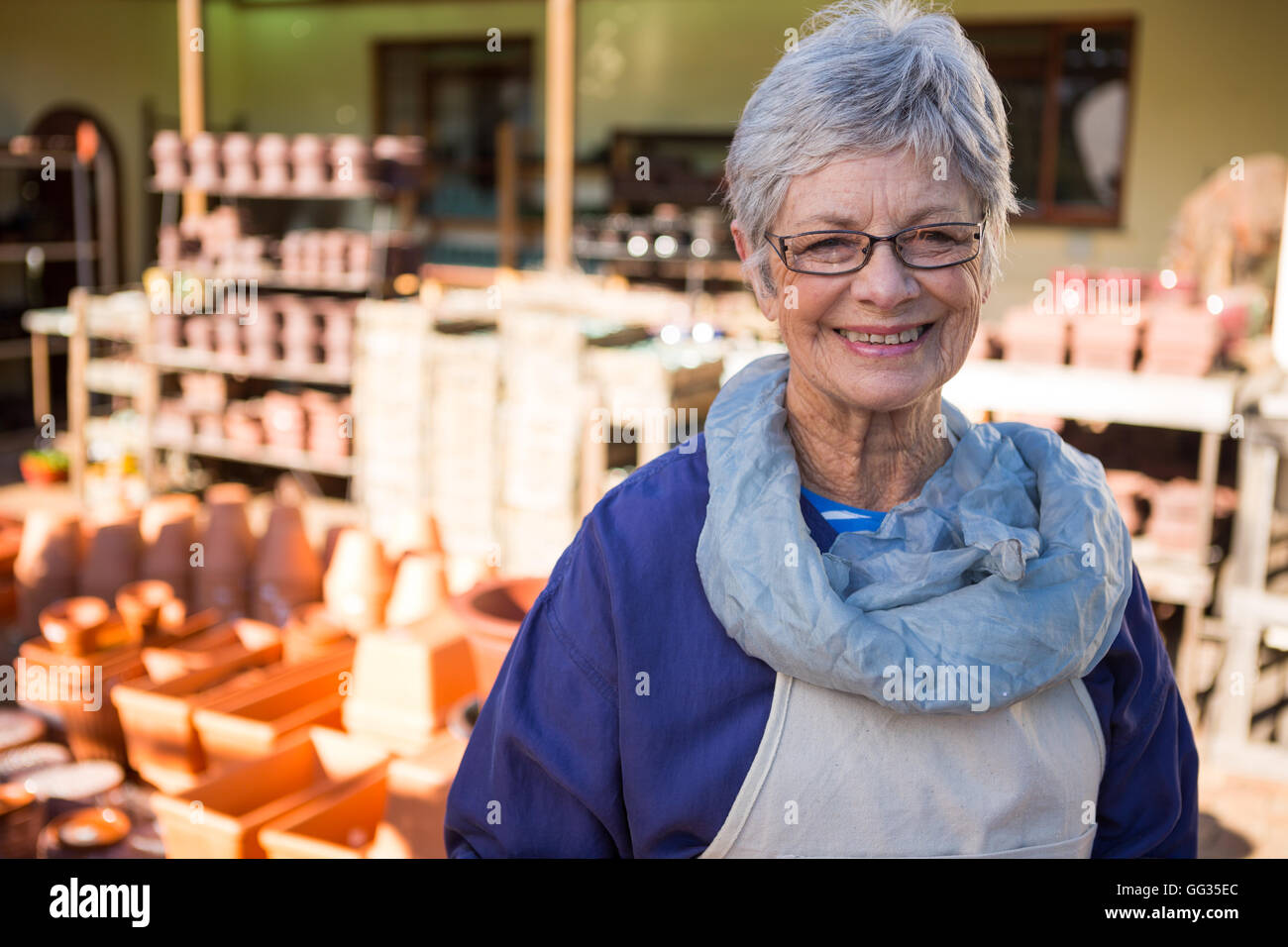 Female potter standing in pottery workshop Stock Photo - Alamy