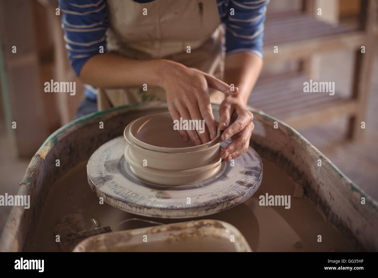 Mid section of female potter making pot Stock Photo - Alamy