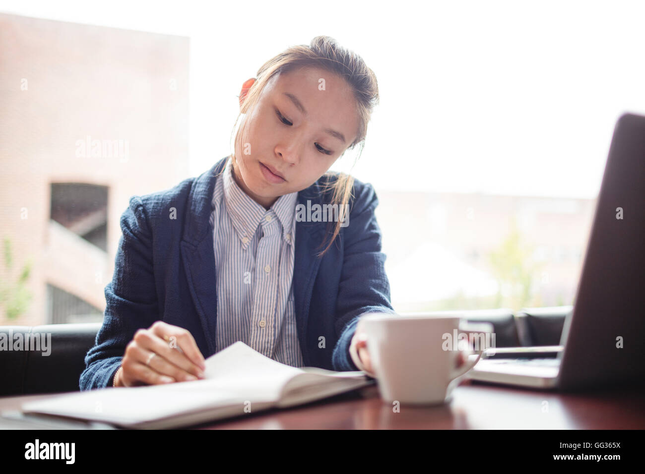 Young woman studying in college Stock Photo - Alamy