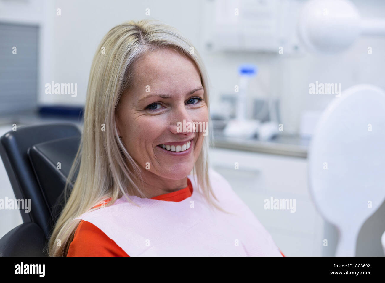Patient checking her teeth in mirror Stock Photo - Alamy