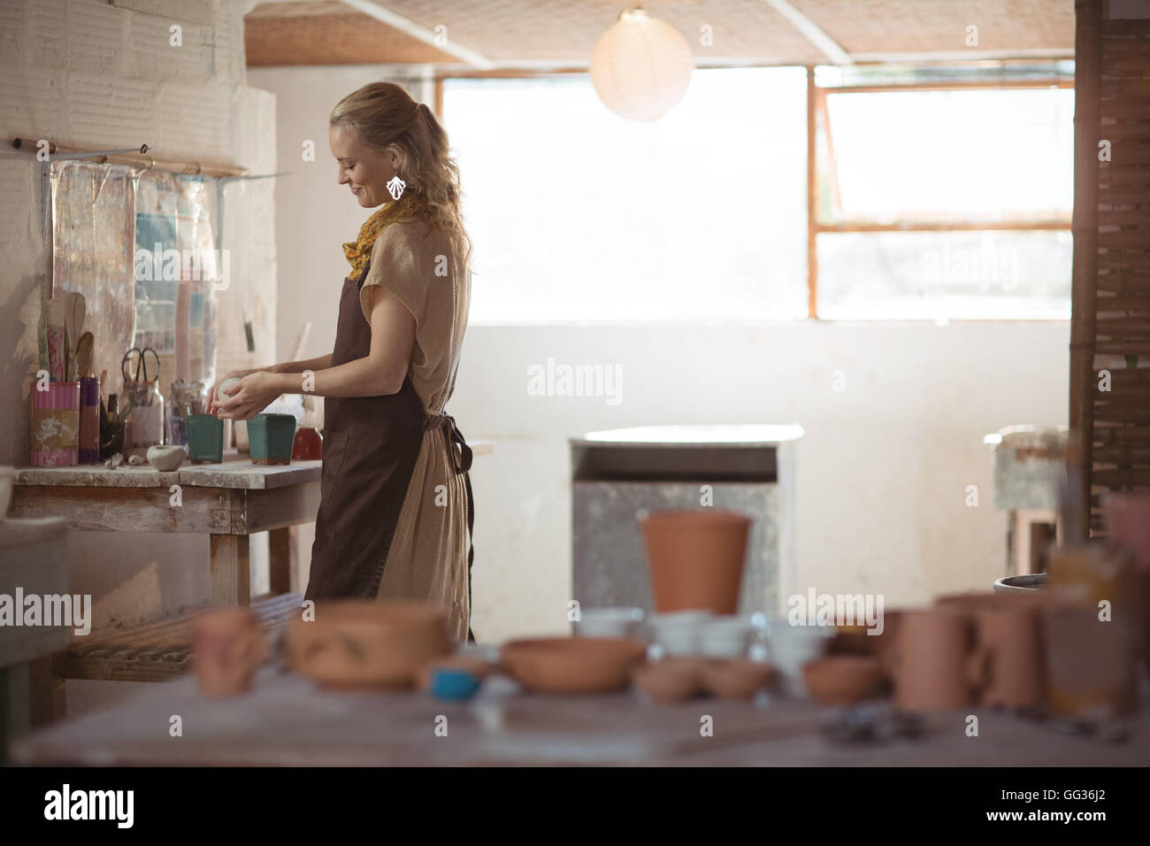 Beautiful female potter molding clay Stock Photo - Alamy