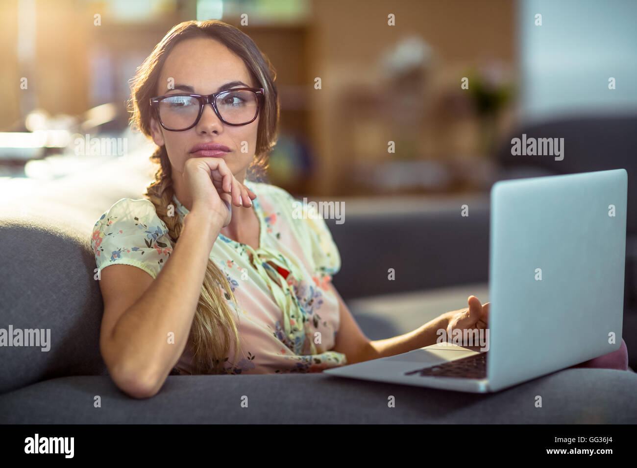 Thinking businesswoman sitting on sofa hi-res stock photography and ...
