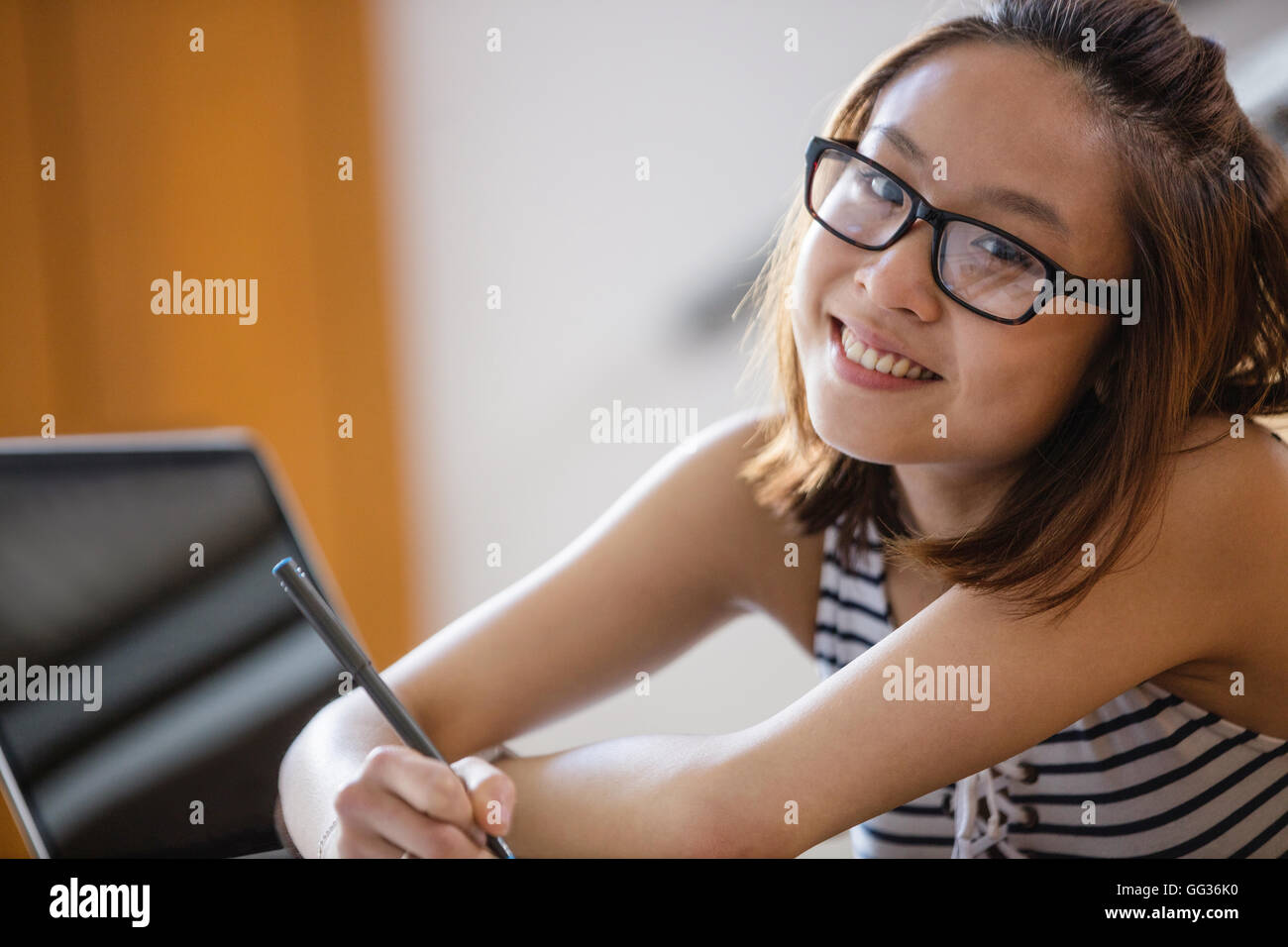 Young woman studying in classroom Stock Photo - Alamy