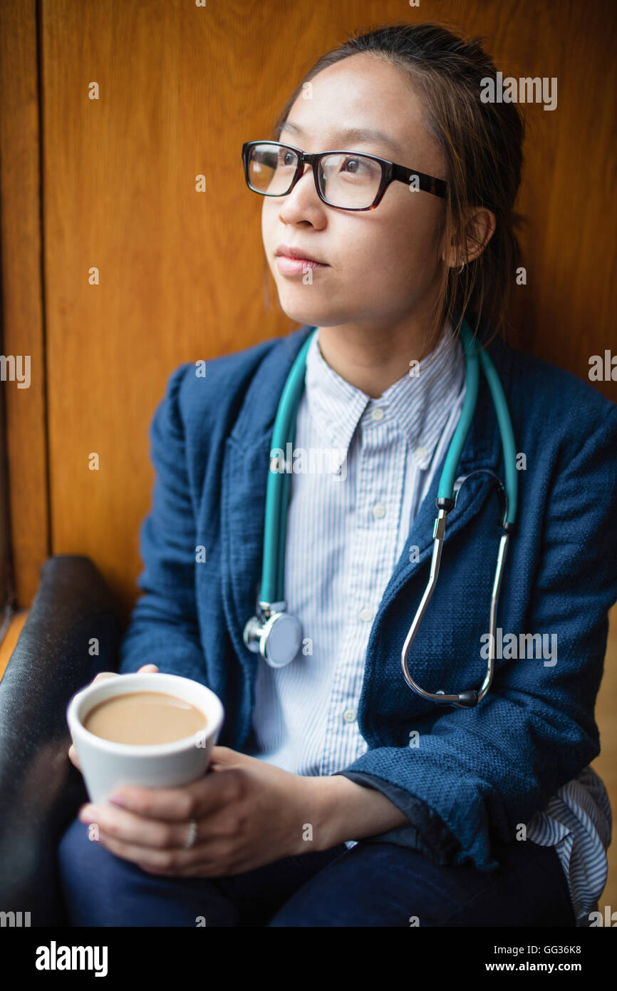 Female doctor having tea in clinic Stock Photo - Alamy