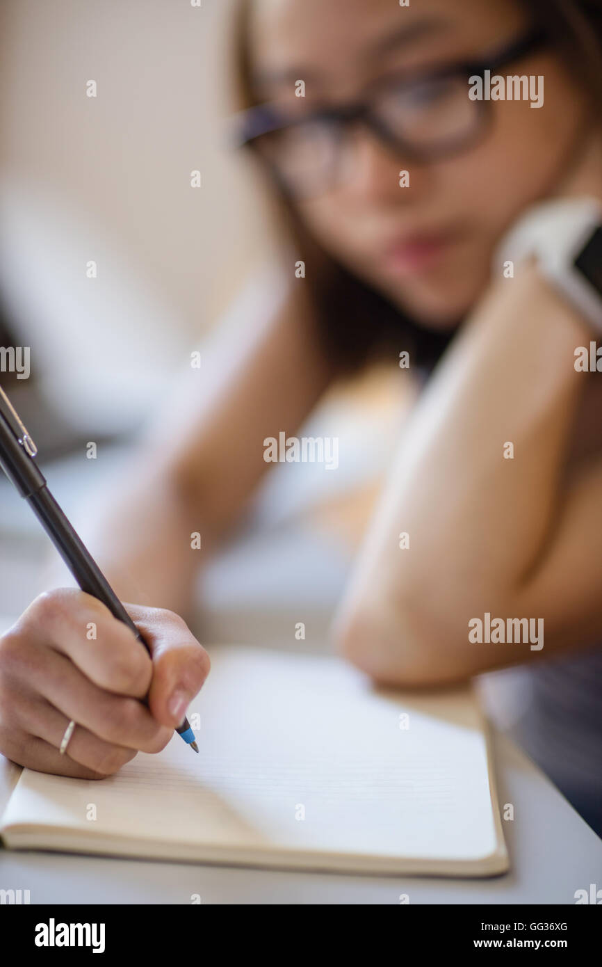 Young woman studying in classroom Stock Photo - Alamy
