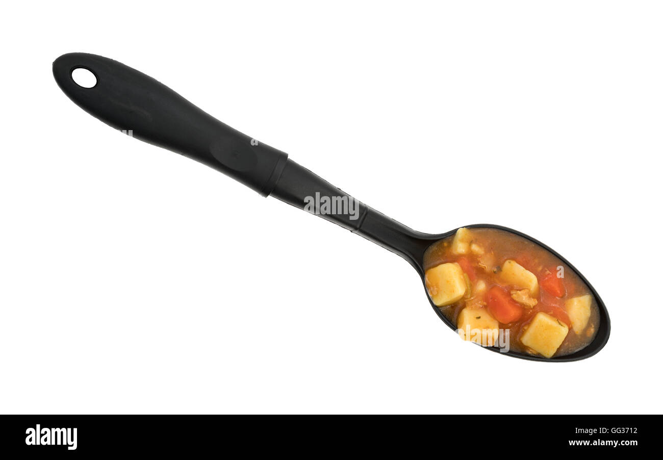 A portion of Manhattan style clam chowder on a large black kitchen ...