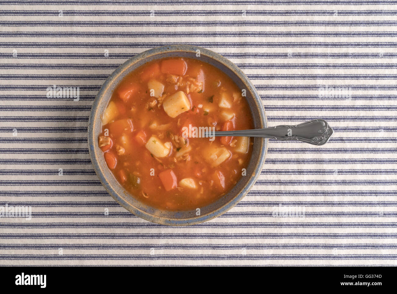 Top view of a serving of Manhattan style clam chowder in an old ...