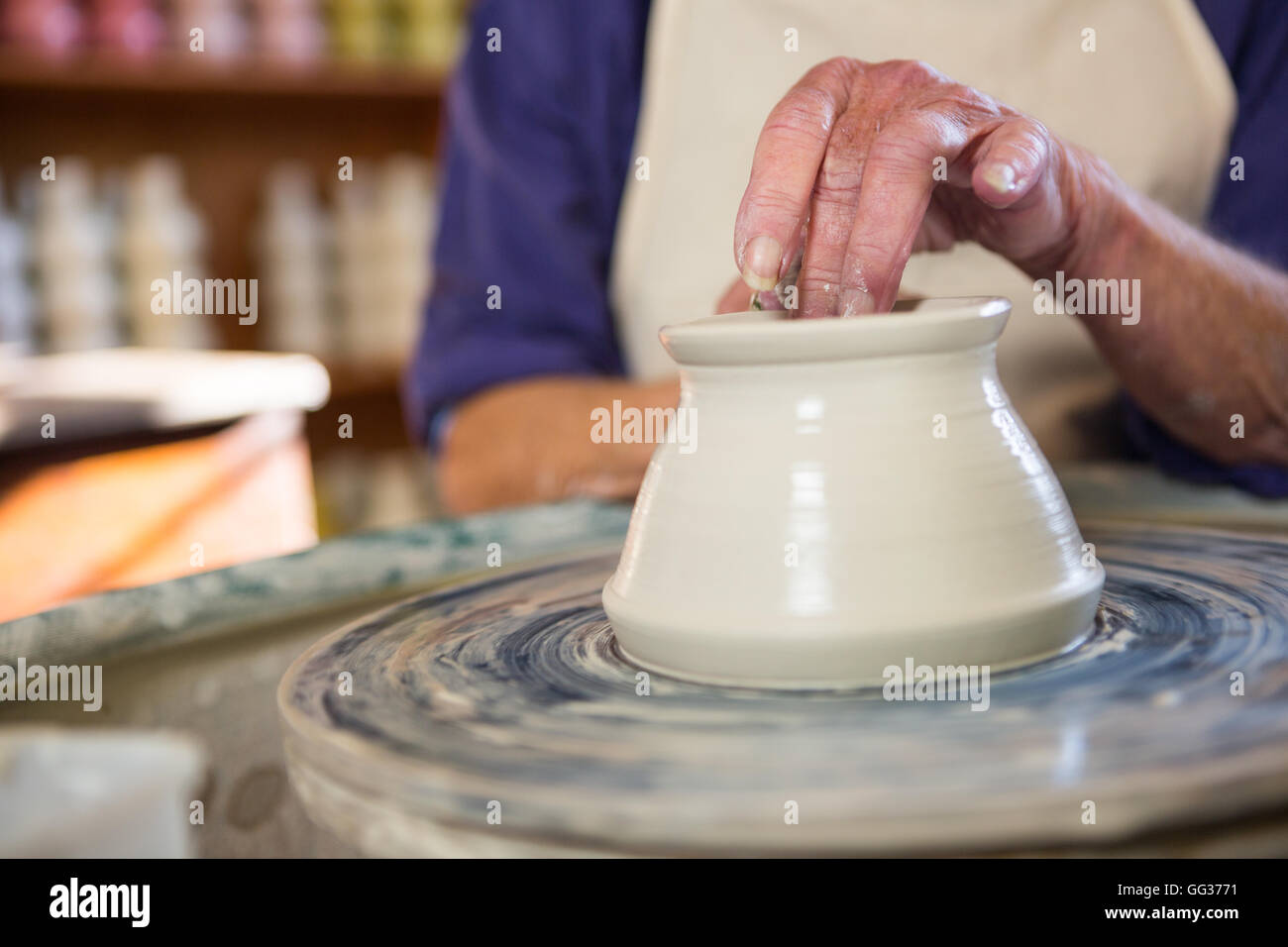 Mid section of potter making pot Stock Photo - Alamy