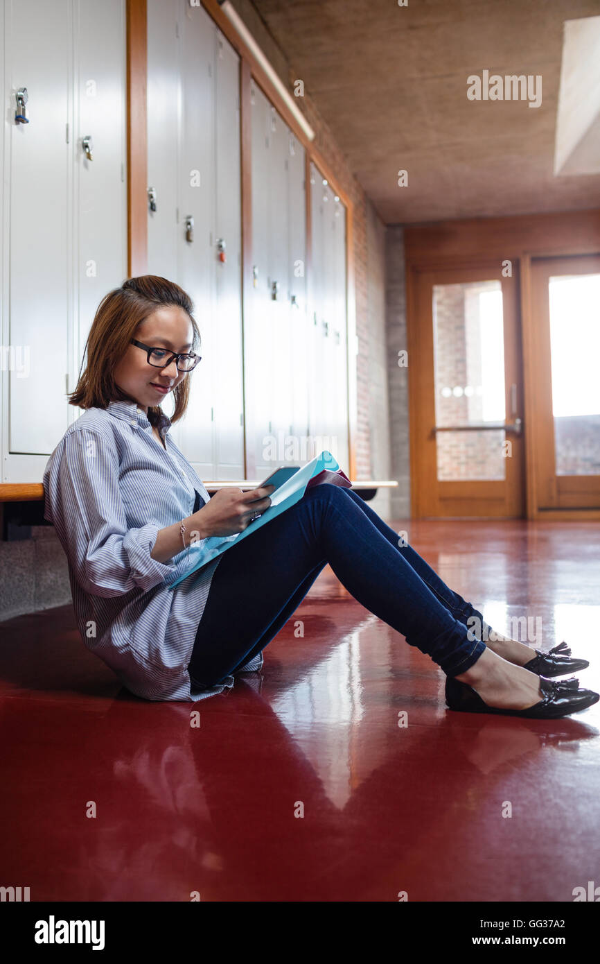 Young woman using mobile phone in locker room Stock Photo - Alamy