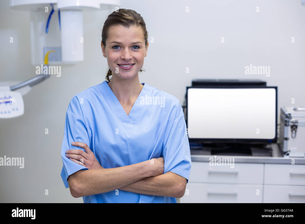 Portrait of dental assistant standing with arms crossed Stock Photo - Alamy