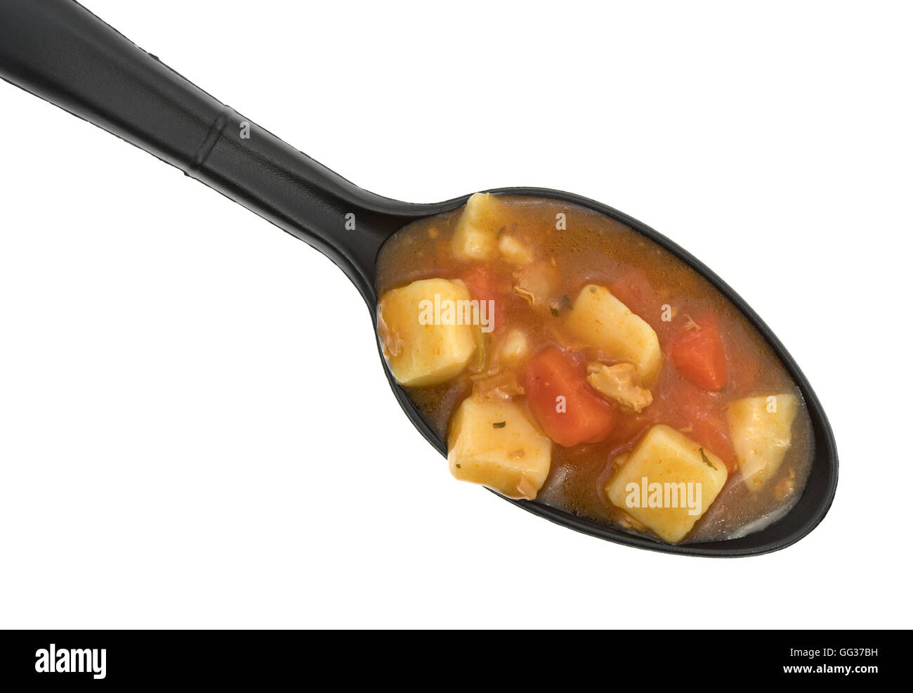 A portion of Manhattan style clam chowder on a large black kitchen ...