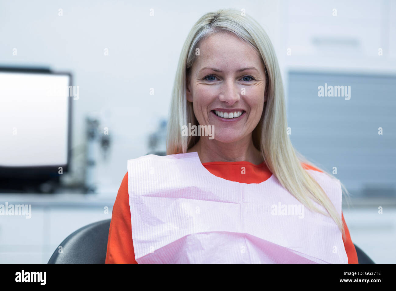 Smiling female patient sitting on dentist chair Stock Photo - Alamy