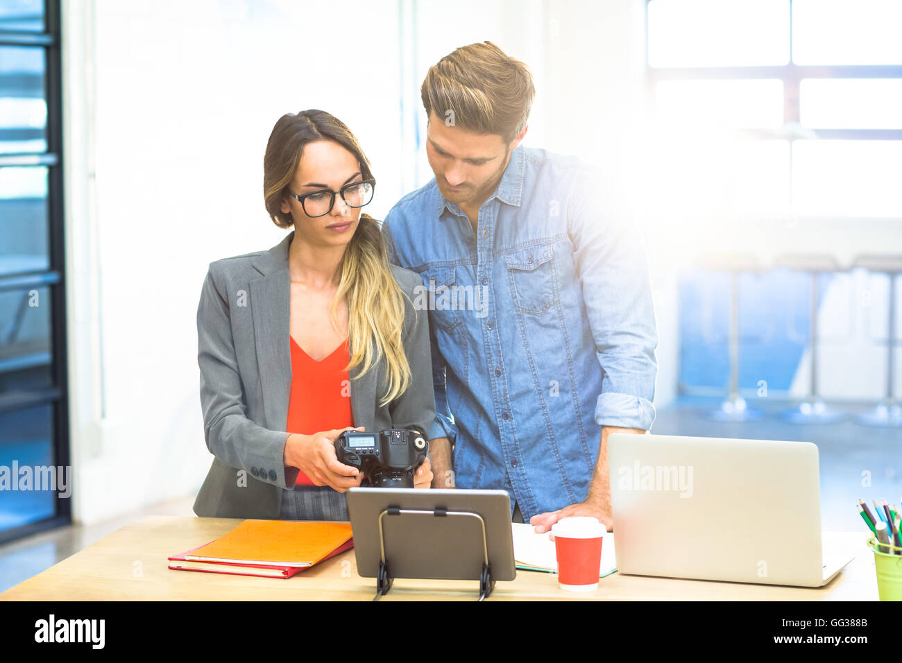 Business executives checking photos in camera Stock Photo - Alamy