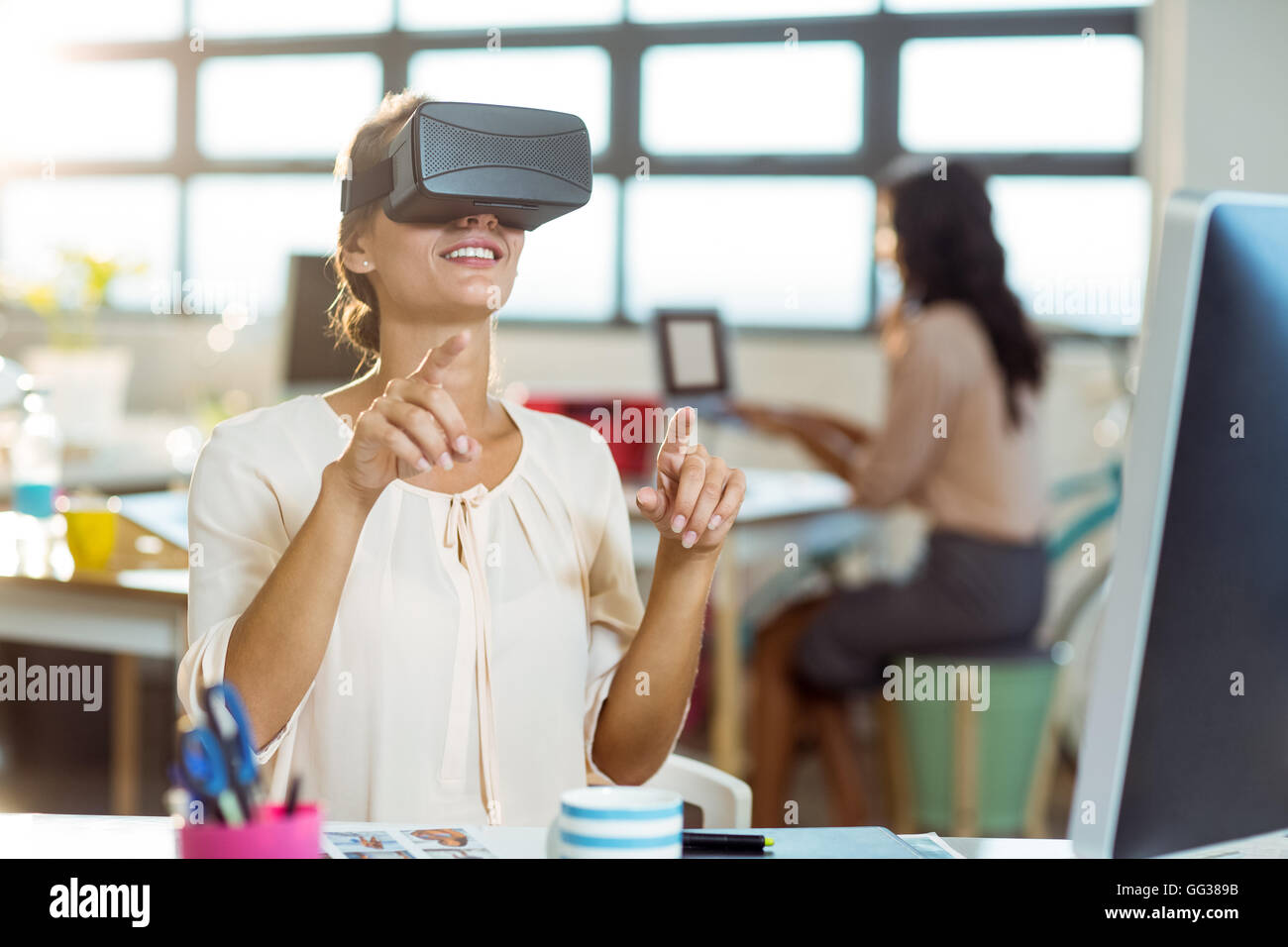 Female graphic designer using the virtual reality headset Stock Photo ...