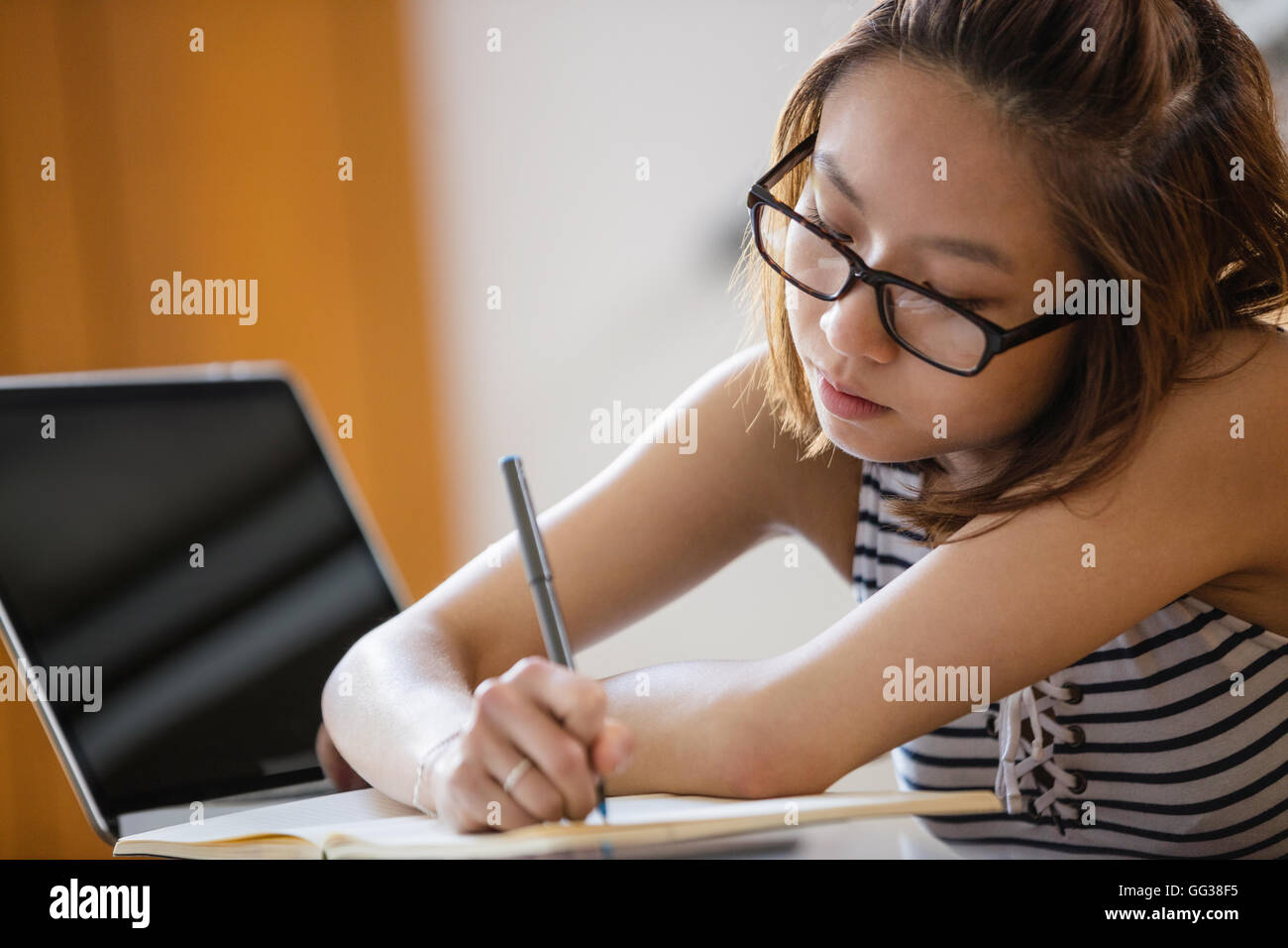 Young woman studying in classroom Stock Photo - Alamy