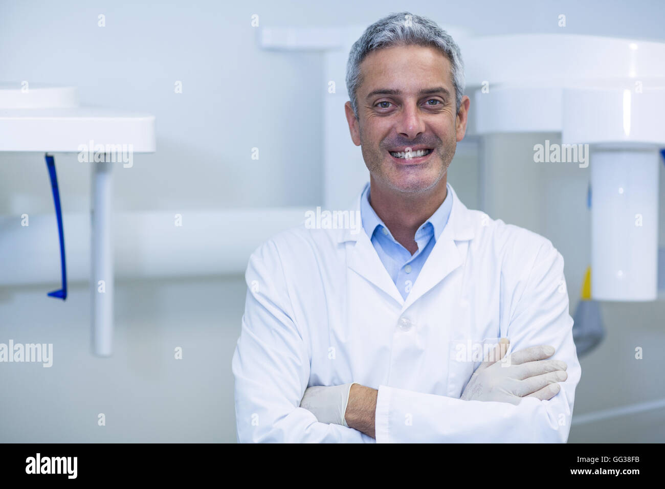 Smiling dentist standing in dental clinic Stock Photo - Alamy