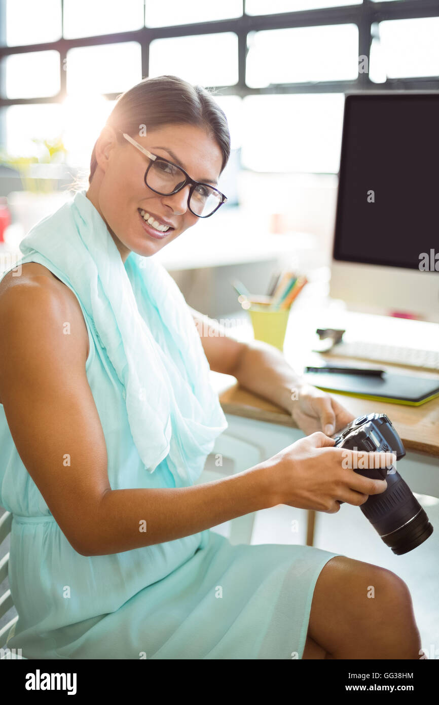Graphic designer holding digital camera Stock Photo - Alamy