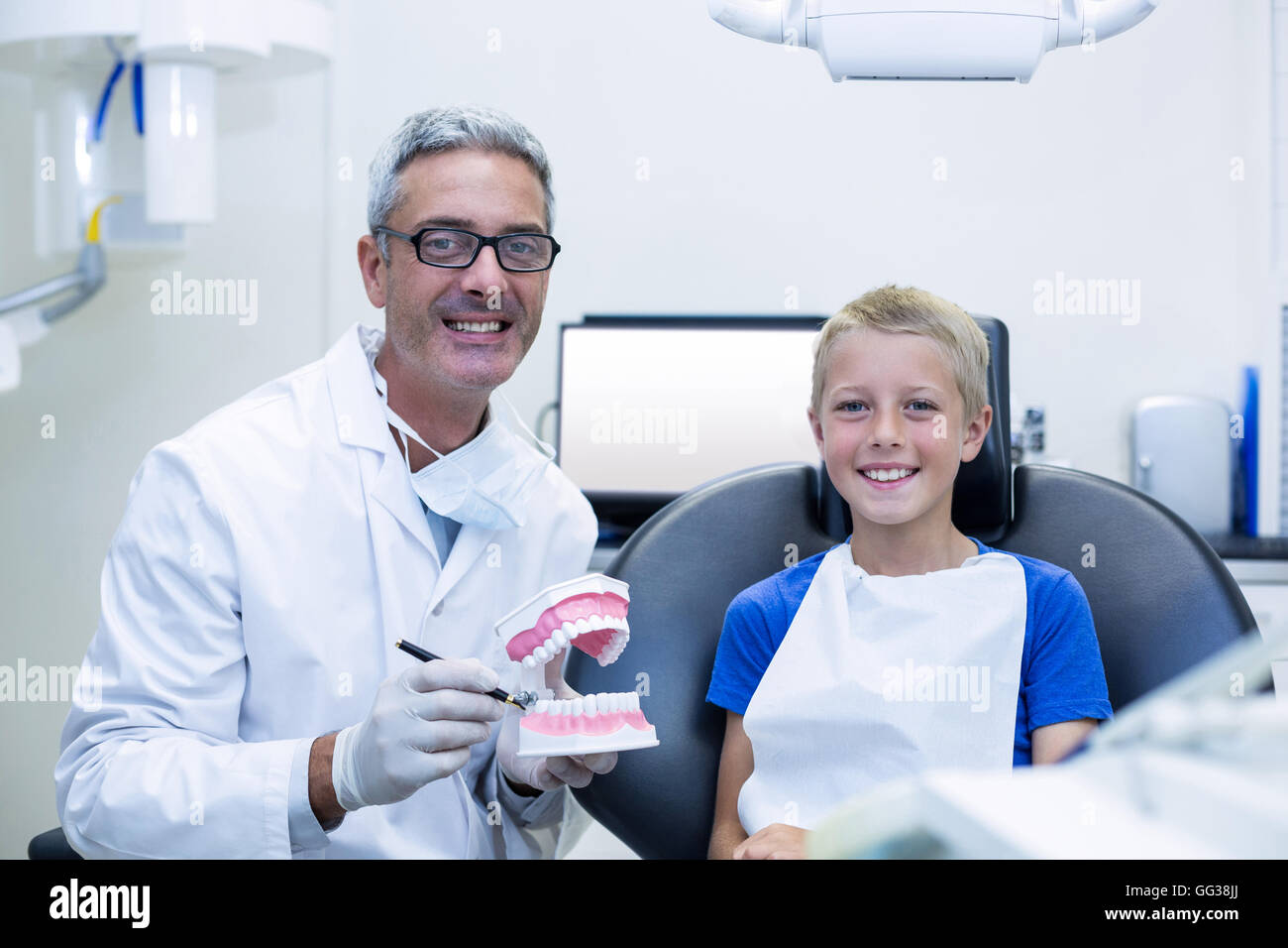 Portrait of smiling dentist and young patient Stock Photo - Alamy