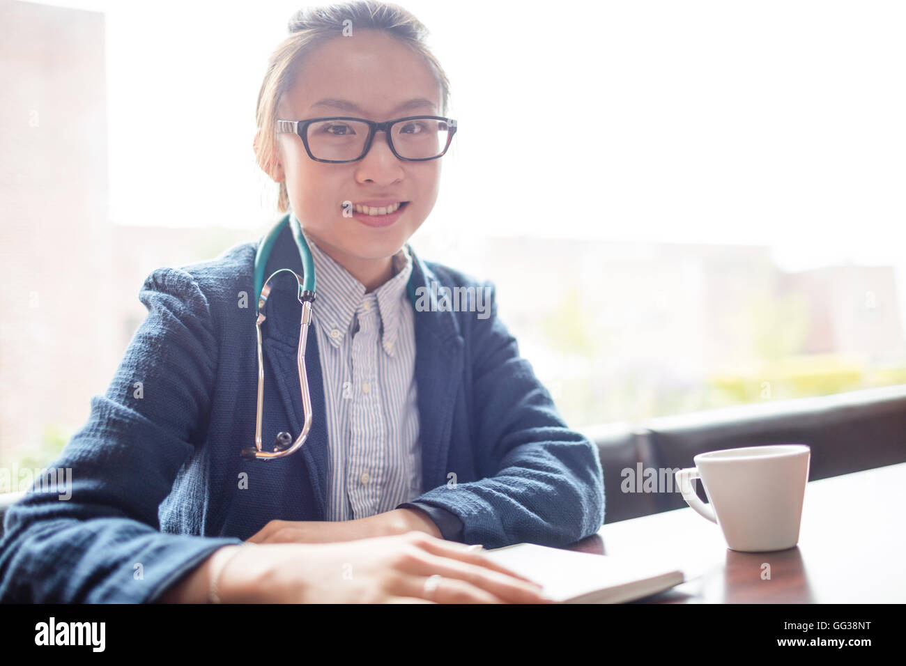Beautiful female doctor sitting hi-res stock photography and images - Alamy