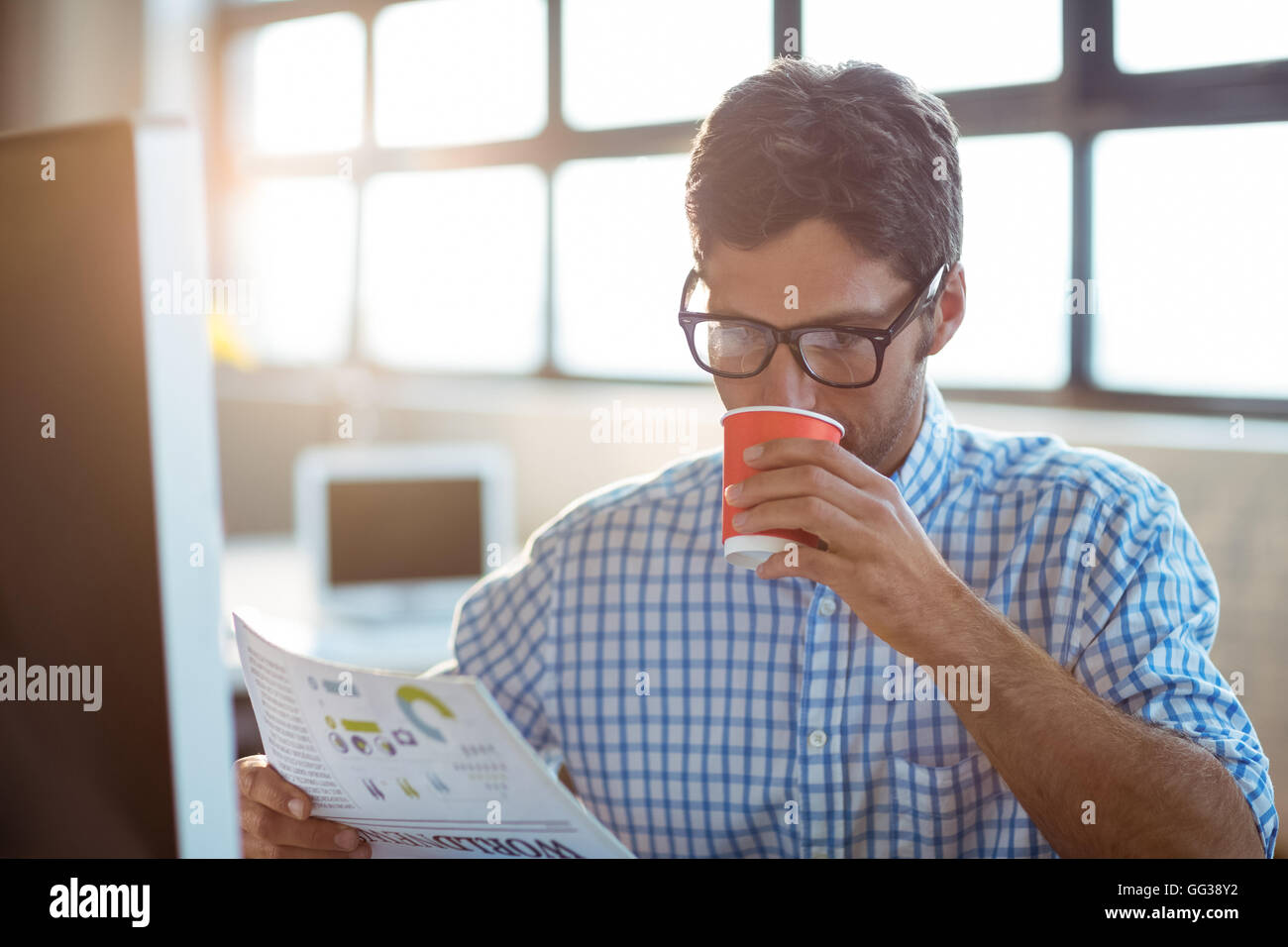 Male business executive reading newspaper while having coffee Stock ...