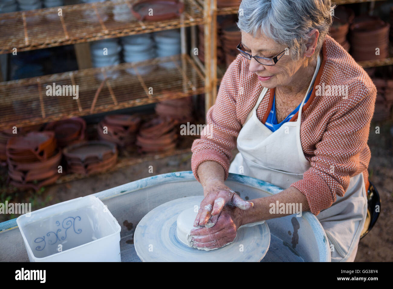 Female potter making clay pot hi-res stock photography and images - Alamy
