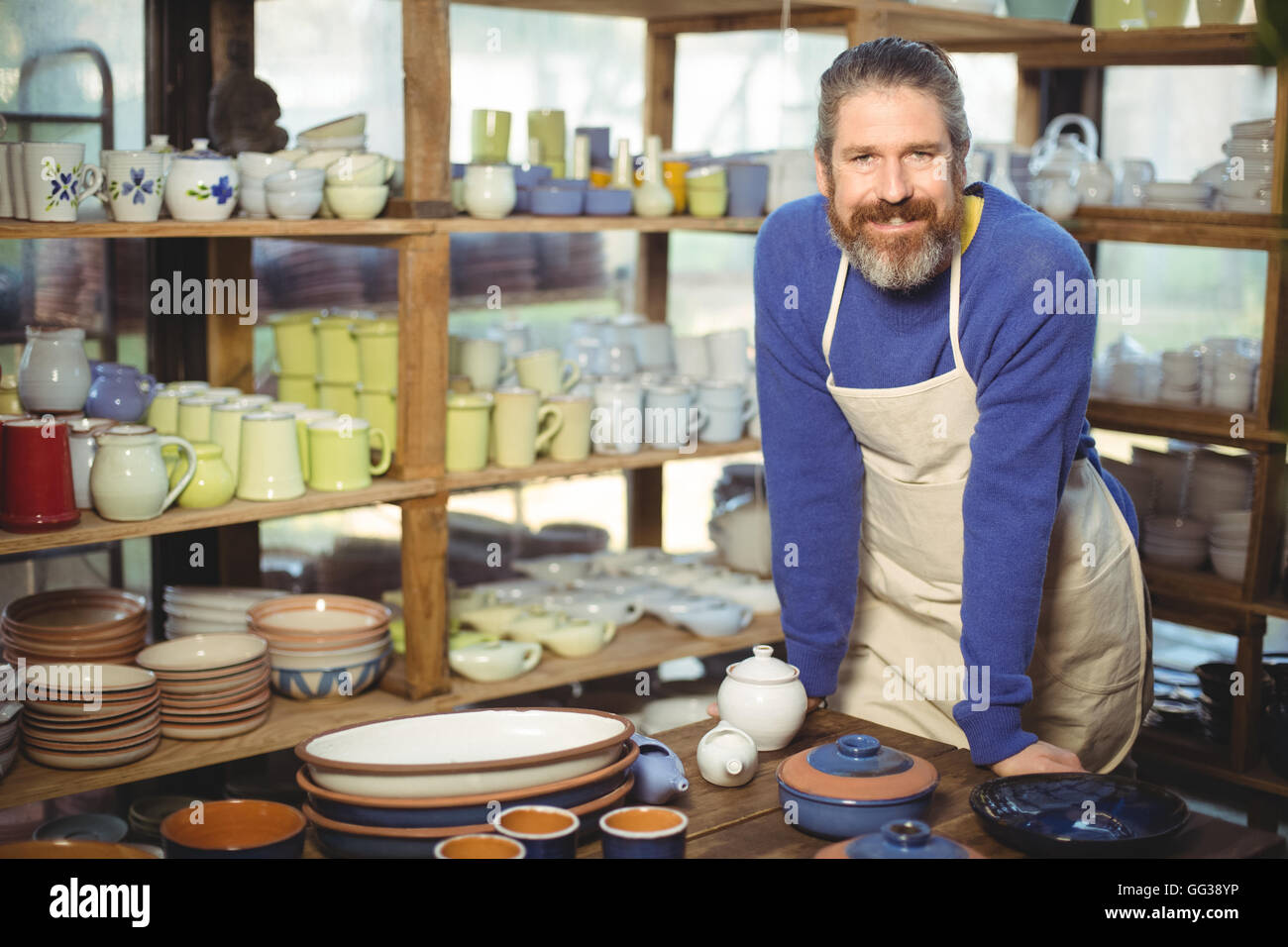 Portrait of male potter standing at table Stock Photo - Alamy