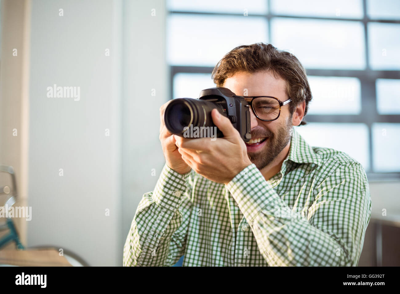 Graphic designer clicking photo from digital camera Stock Photo - Alamy
