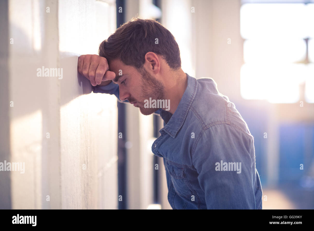 Tired man leaning wall hi-res stock photography and images - Alamy