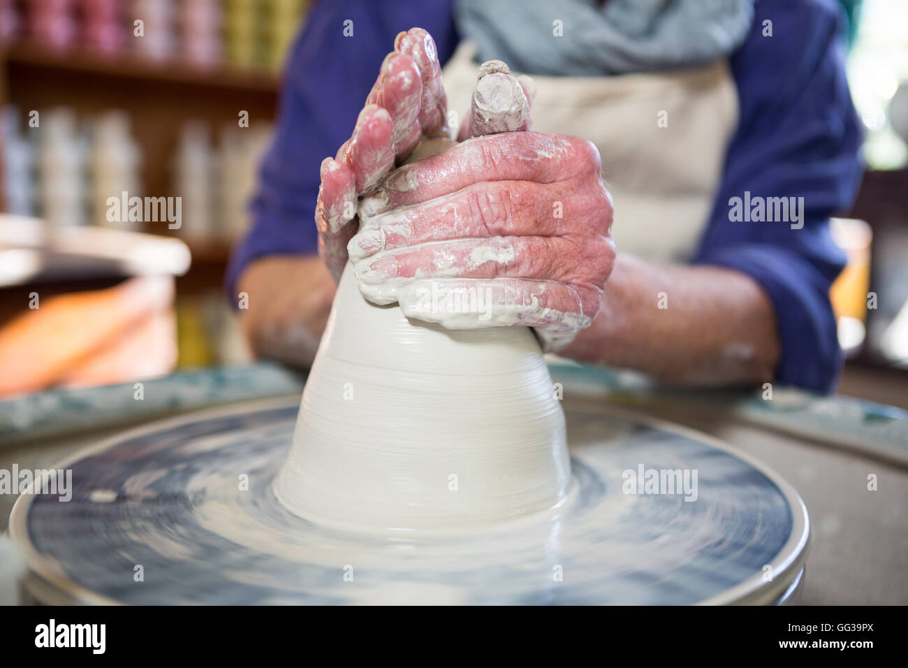 Mid section of female potter making pot Stock Photo - Alamy