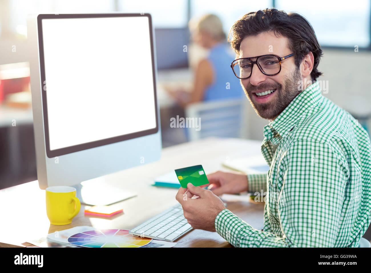 Graphic designer doing online shopping Stock Photo - Alamy