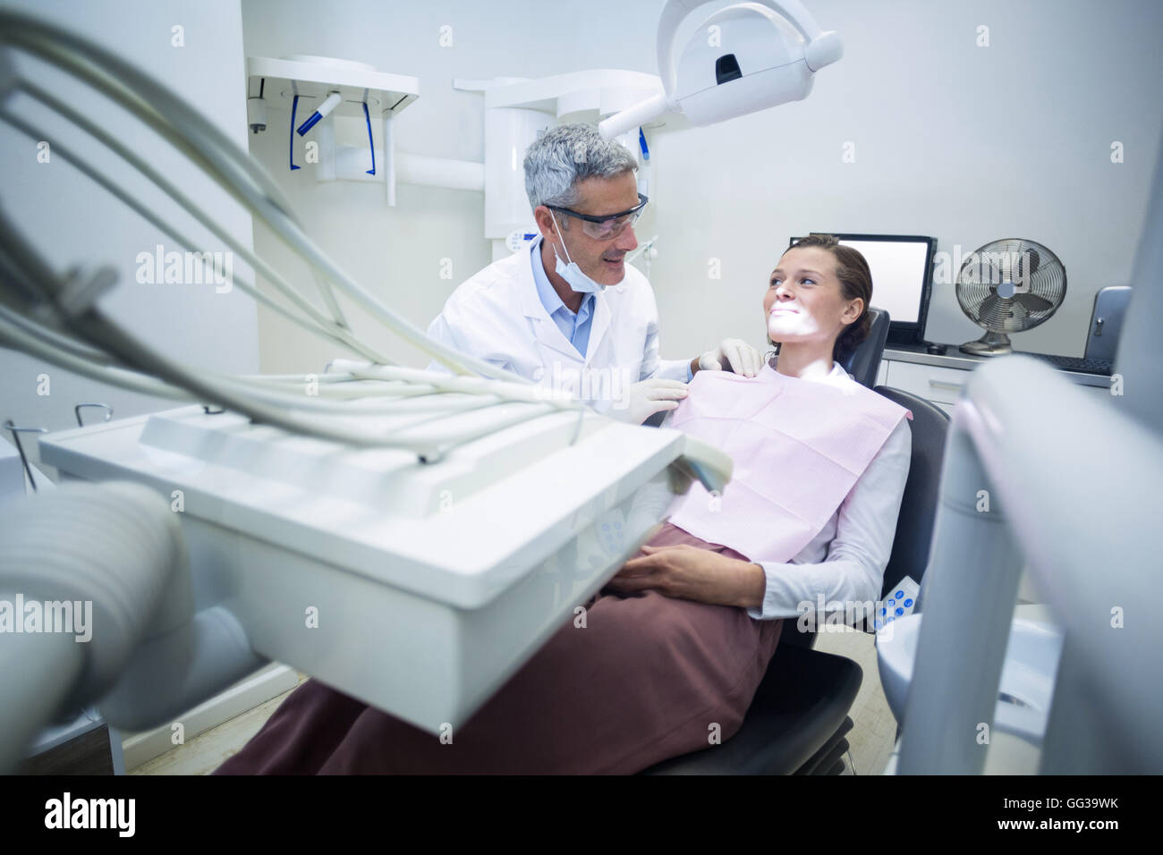 Smiling dentist talking to patient Stock Photo - Alamy