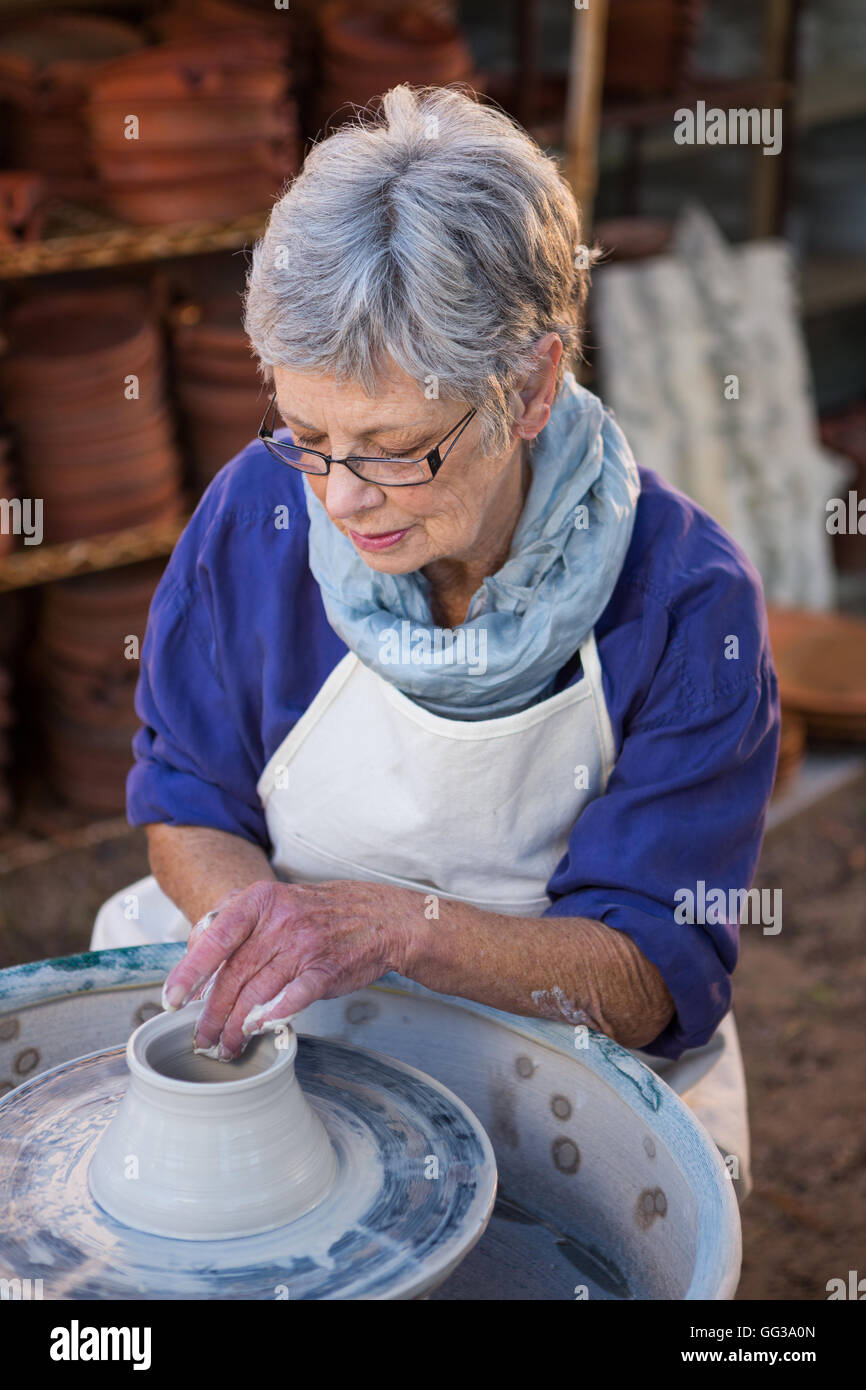 Female potter making pot Stock Photo - Alamy