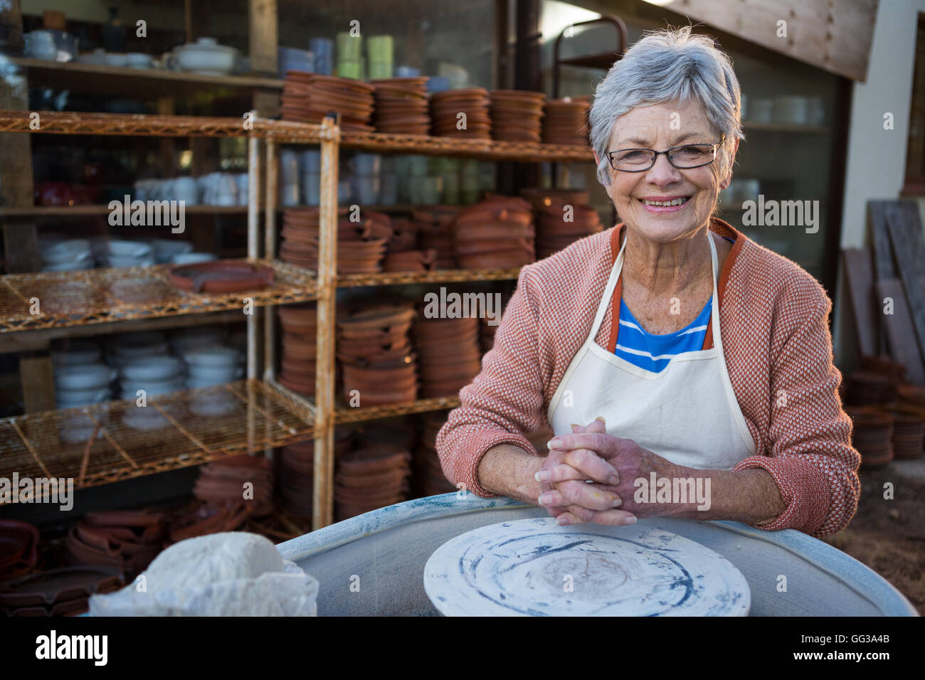 Female potter smiling in pottery workshop Stock Photo - Alamy