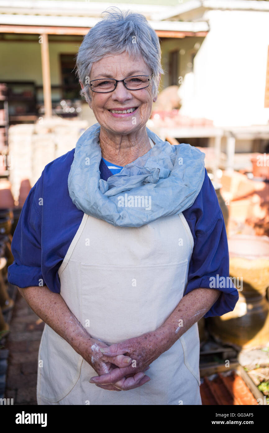 Female potter standing in pottery workshop Stock Photo - Alamy