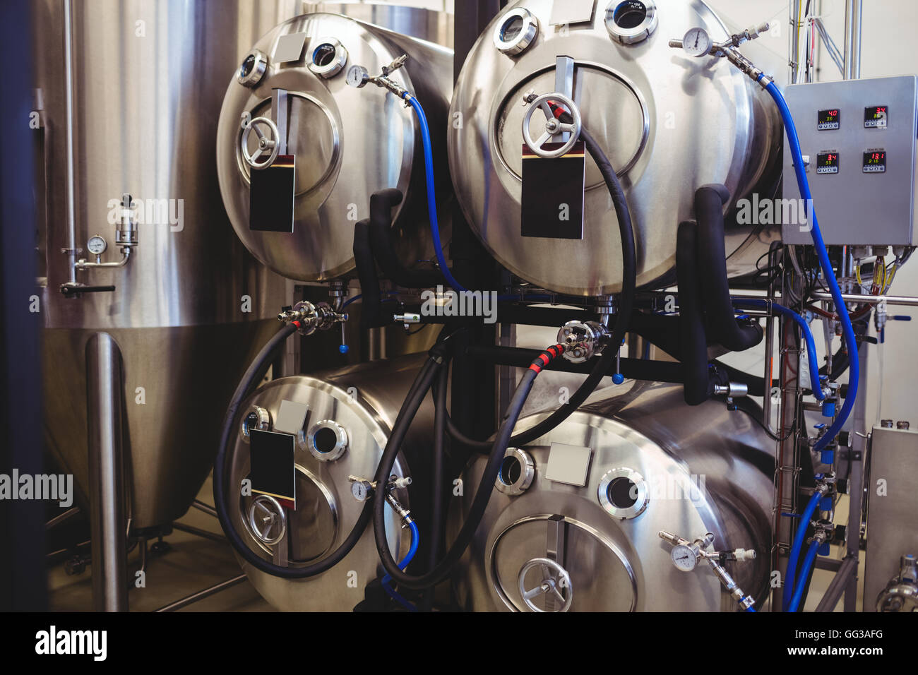 Storage tanks with pipes at brewery Stock Photo - Alamy