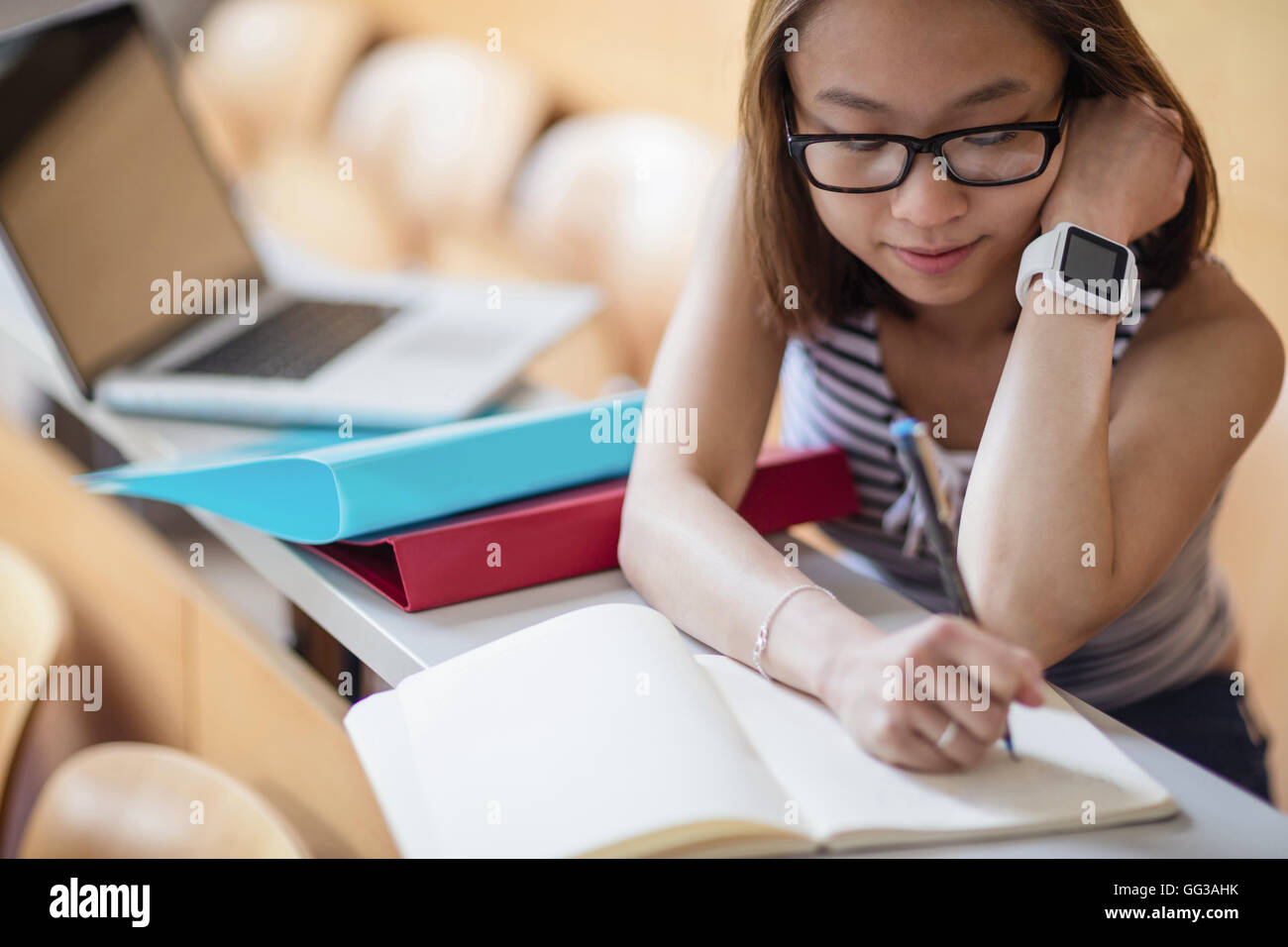 Young woman studying in classroom Stock Photo - Alamy