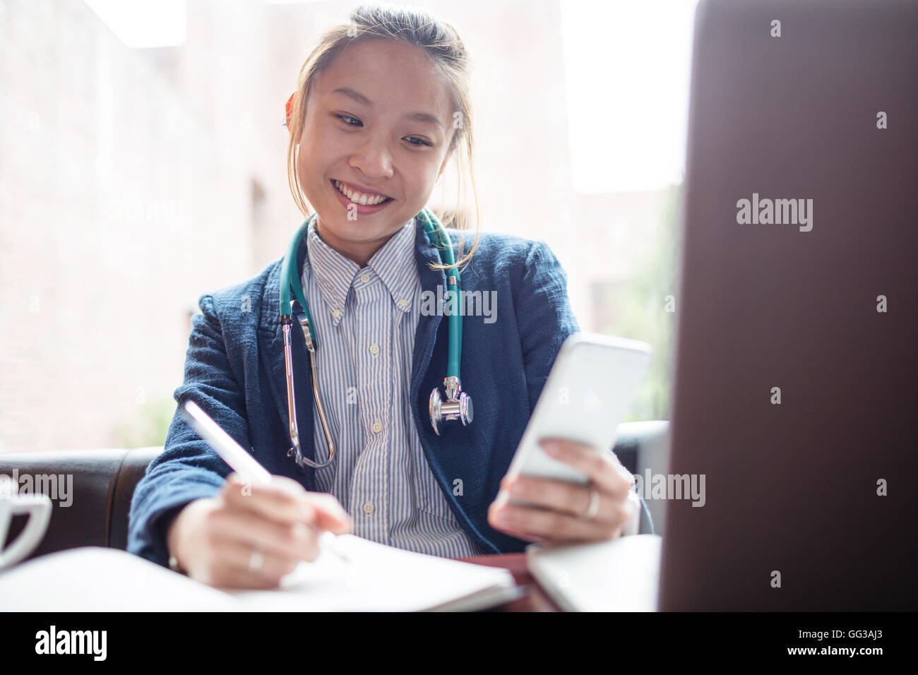 Female doctor using mobile phone Stock Photo - Alamy