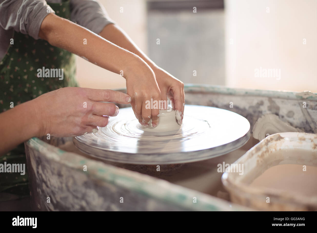 Female potter assisting girls Stock Photo - Alamy