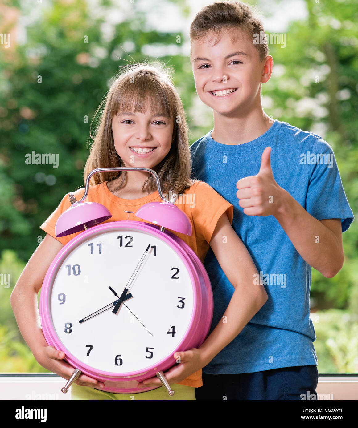 Children with big clock Stock Photo - Alamy