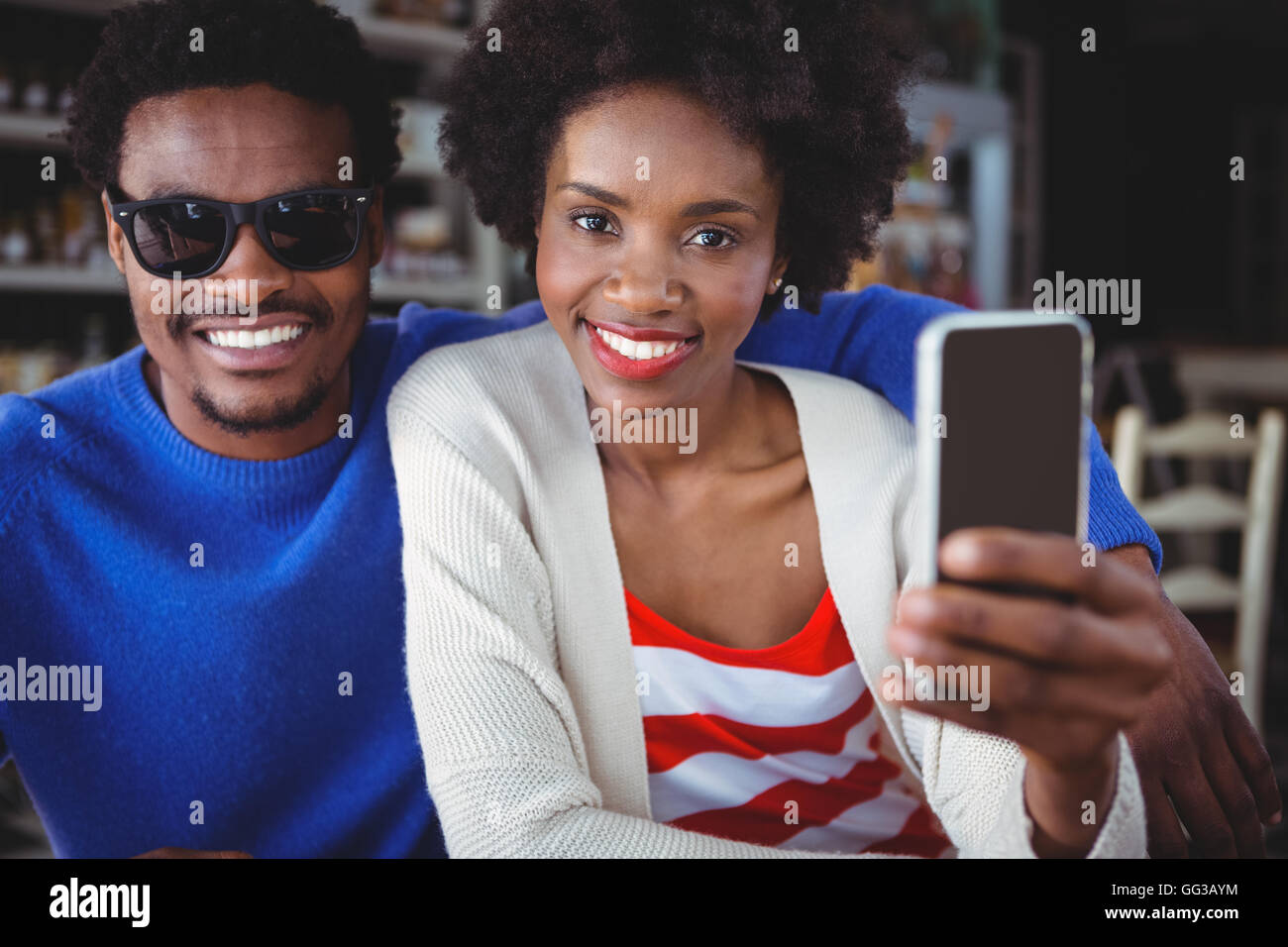 Smiling couple taking a selfie Stock Photo - Alamy