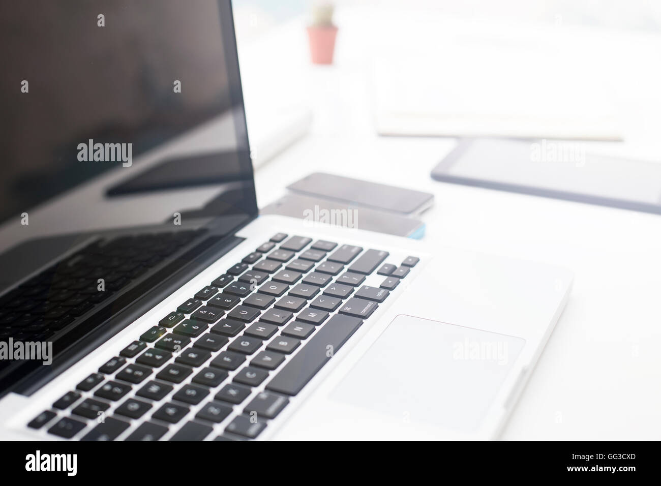 Detail of the office desk with laptop and mobile phone Stock Photo - Alamy