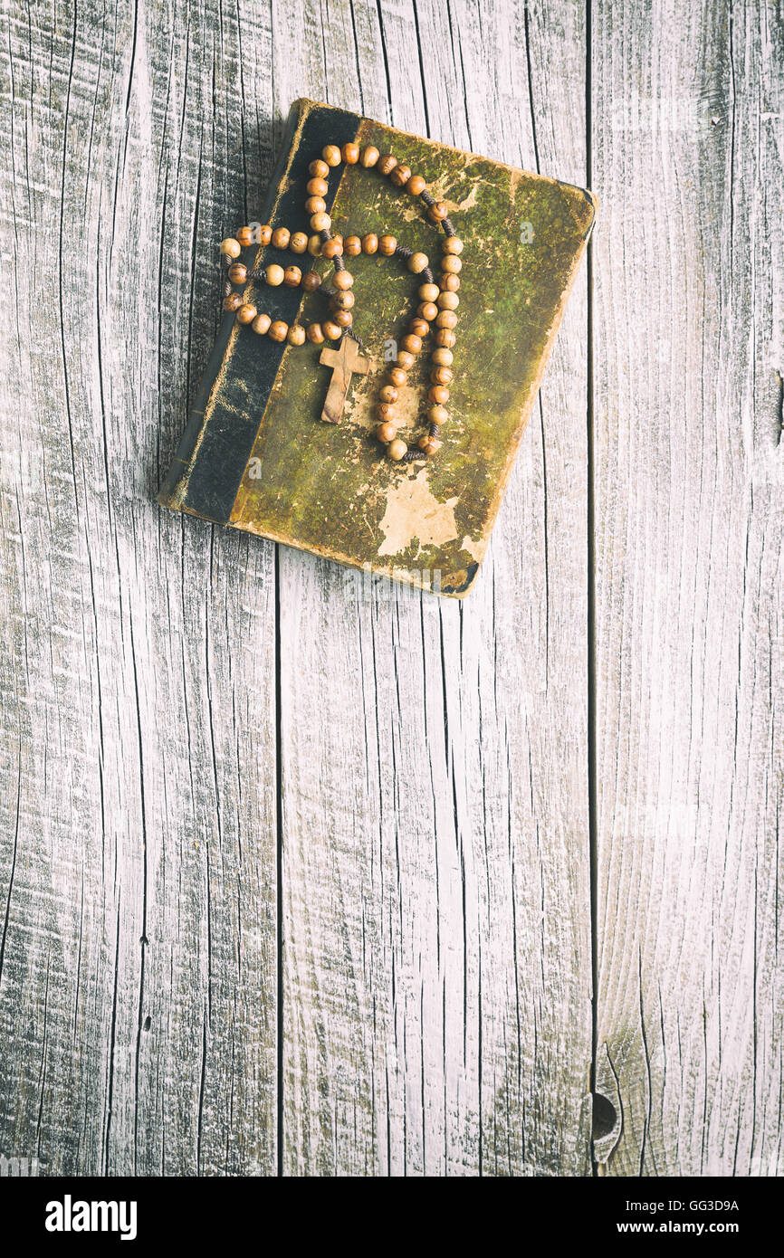 rosary beads and holy bible on old wooden table Stock Photo - Alamy