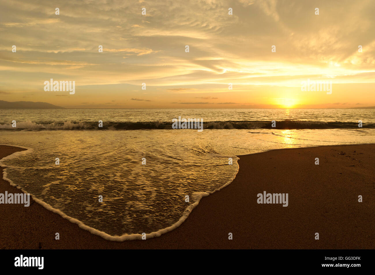 Ocean sunset is a brightly beach with the sun setting on the ocean ...