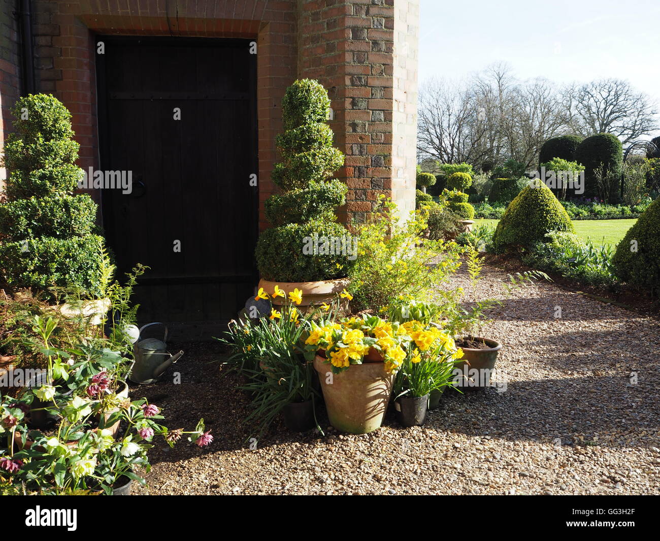 Chenies Manor, Bucks, corner doorway and shingle path to the lawn edged ...