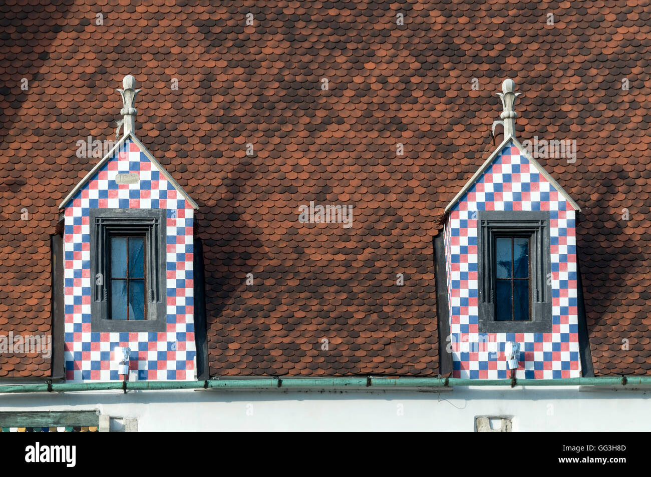 On a roof of coloured glazed tiled window surrounds on the Old Town ...