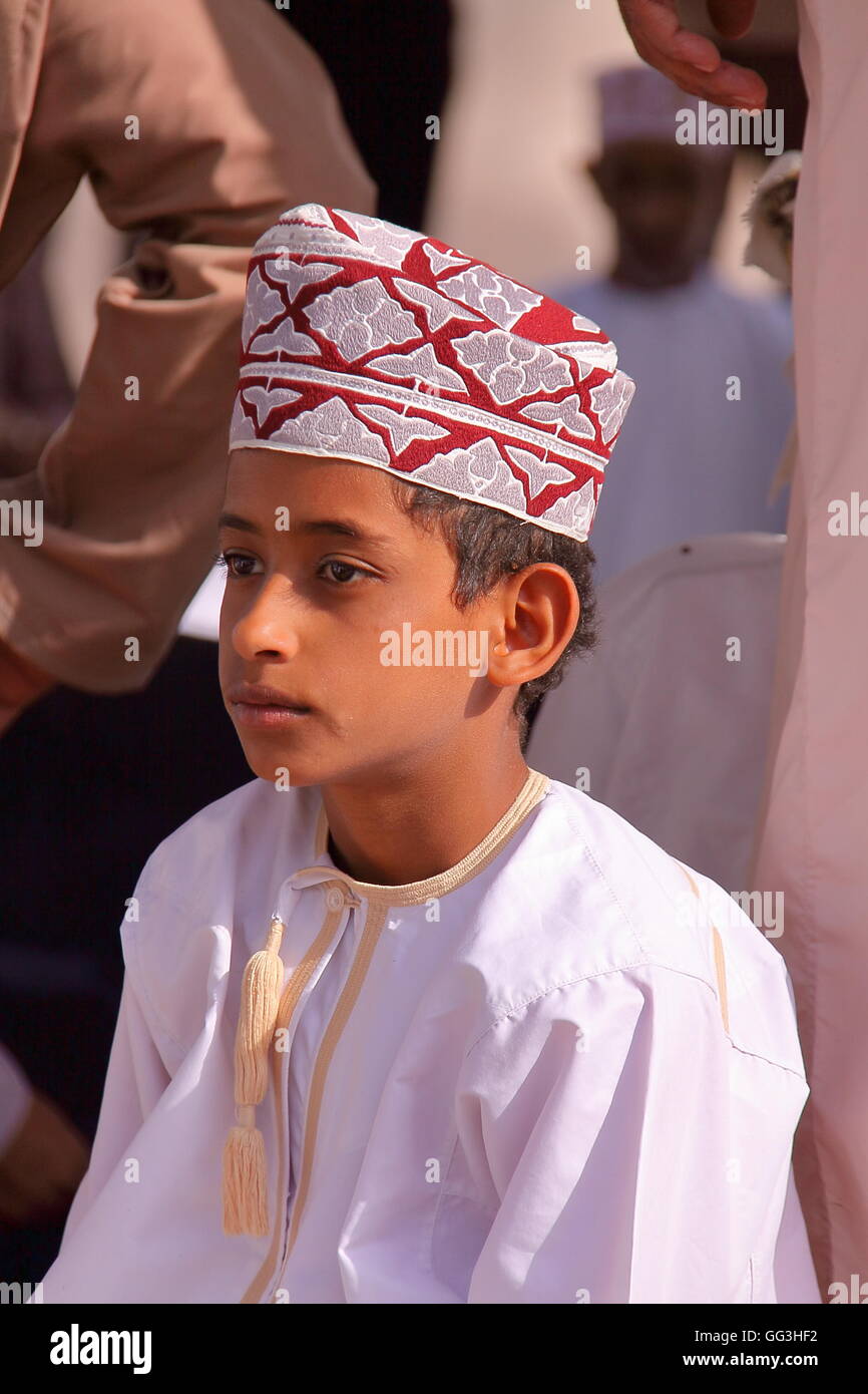 Portrait of a little Omani boy traditionally dressed attending the Goat ...